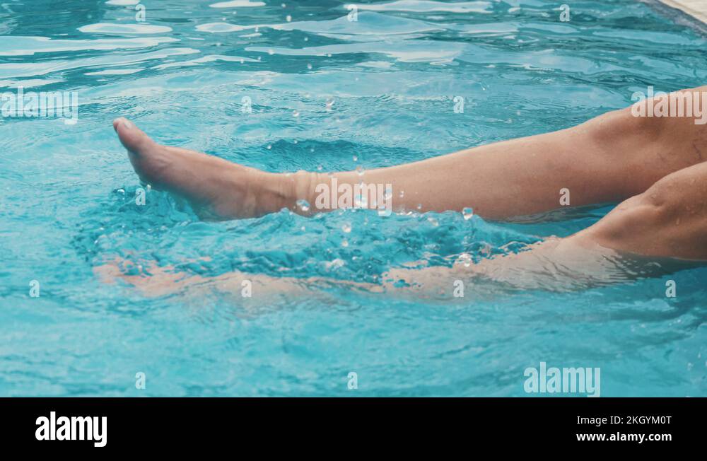 Jolly legs splashing water in a swimming pool in summer in Turkey in ...