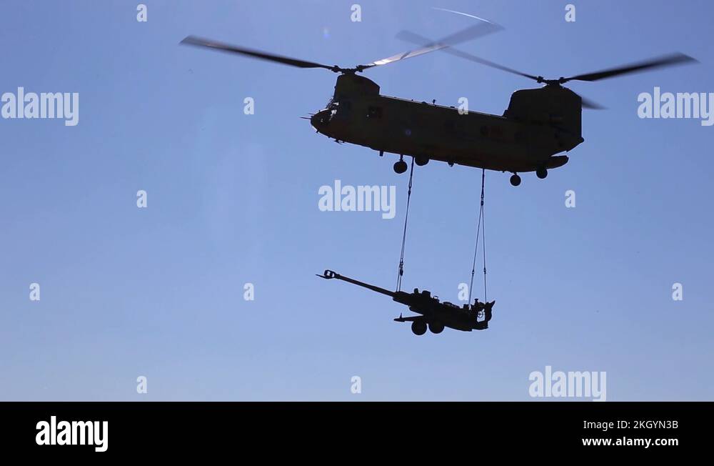 CH-47 Chinook transporting M777 Howitzer by sling load Stock Video Footage - Alamy