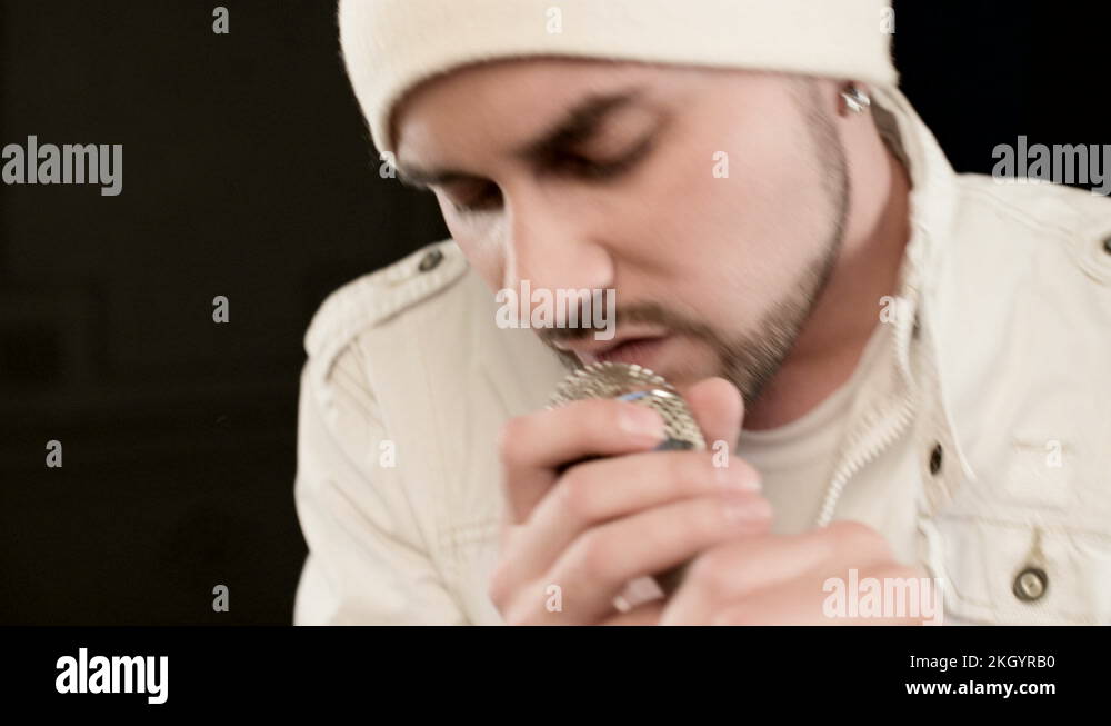Close-up Frontman vocalist rock pop with a stylish beard in white ...