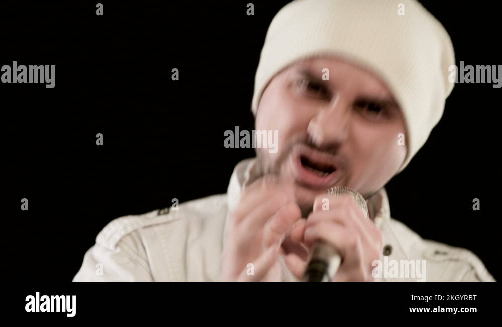 Close-up Frontman vocalist rock pop with a stylish beard in white ...