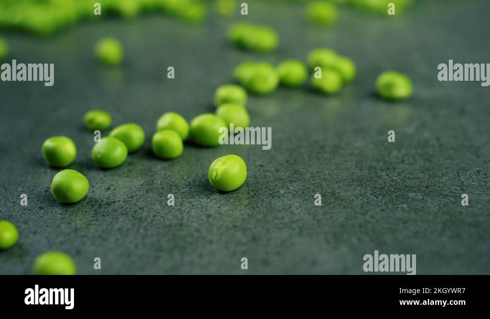 Green fresh pea falling in slow motion. Close up food background video ...