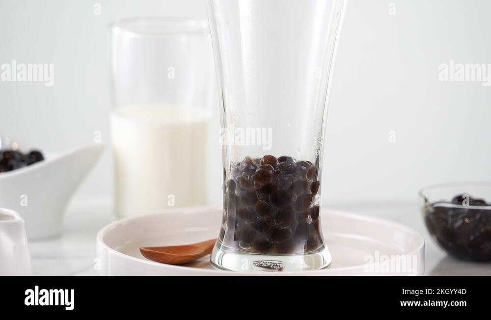 Slow motion - pouring milk tea in glass cup with taiwan tapioca pearl ...