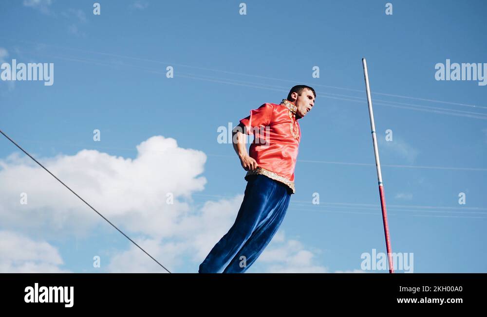 The man performs a rotation around its axis tied to the rope Stock ...