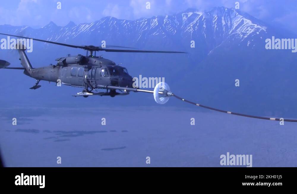 Aerial refuelling of UH-60 Black Hawk helicopter with drogue above ...