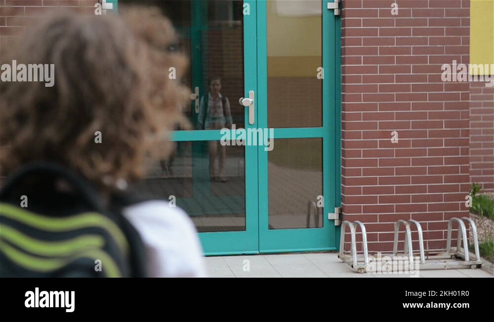 Four Pupils Are Entering To School Doors. They Wear School Uniform ...