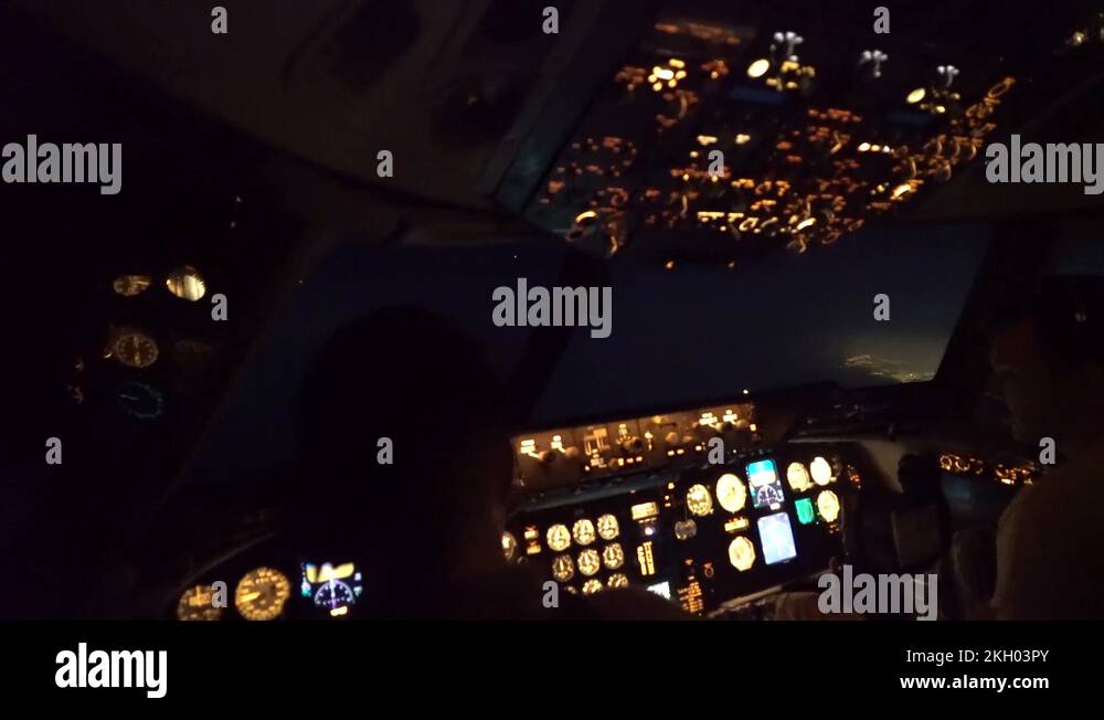 Pilots flying KC-10 Extender at night with cockpit control panels ...