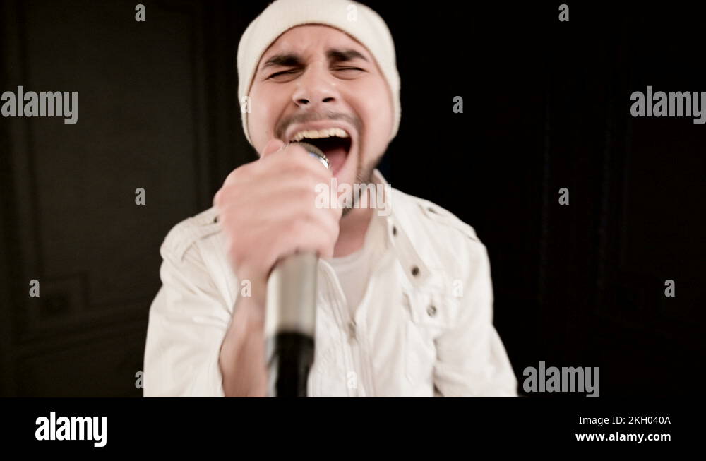 Close-up Frontman vocalist rock pop with a stylish beard in white ...