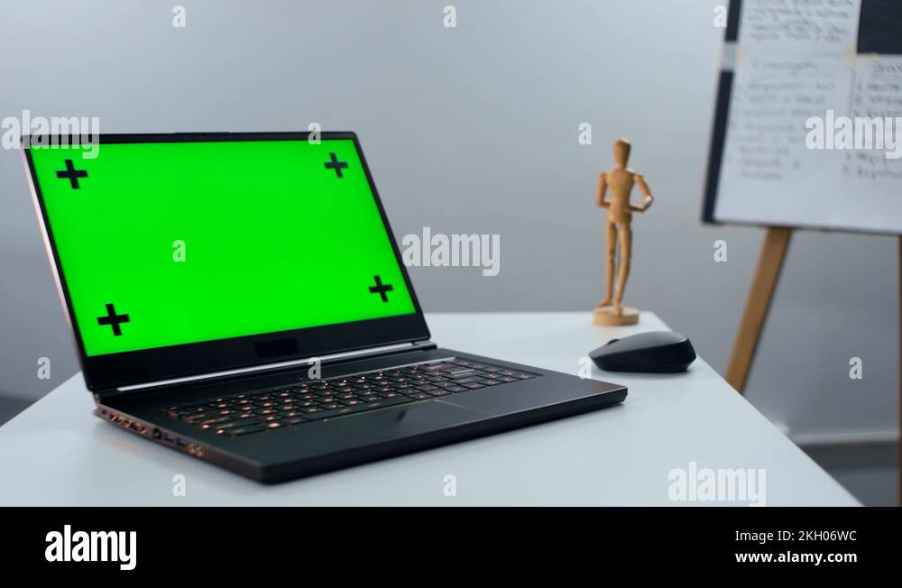 Laptop with a green screen (chroma key) and tracking markers. Bright ...