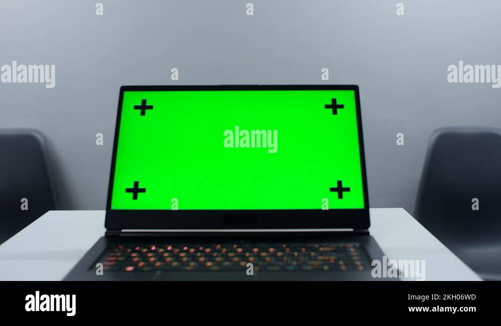 Laptop with a green screen (chroma key) and tracking markers. Bright ...