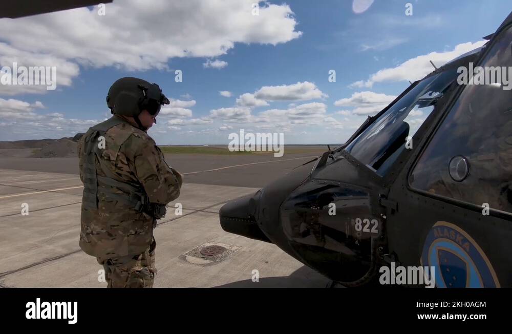 U.S. Army crewman conducts pre-flight walk around checks on UH-60 Black ...