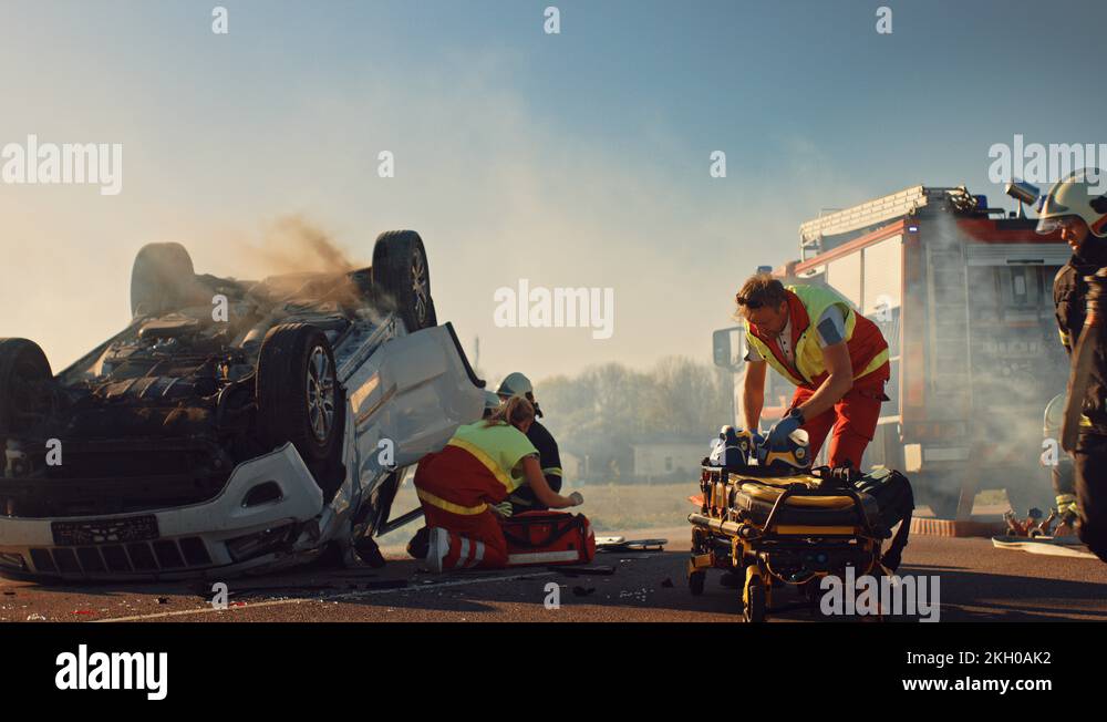 On Car Crash Traffic Accident Scene: Paramedics and Firefighters Rescue ...