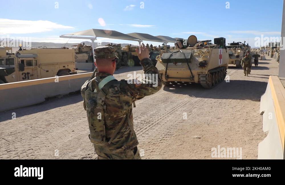 Crewman directing armored personnel carrier arriving at Fort Irwin ...