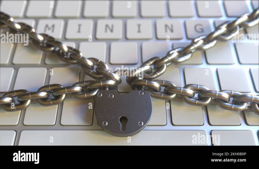 MINING text on the keys of a keyboard with padlock and chains. Restriction Stock Video Footage ...