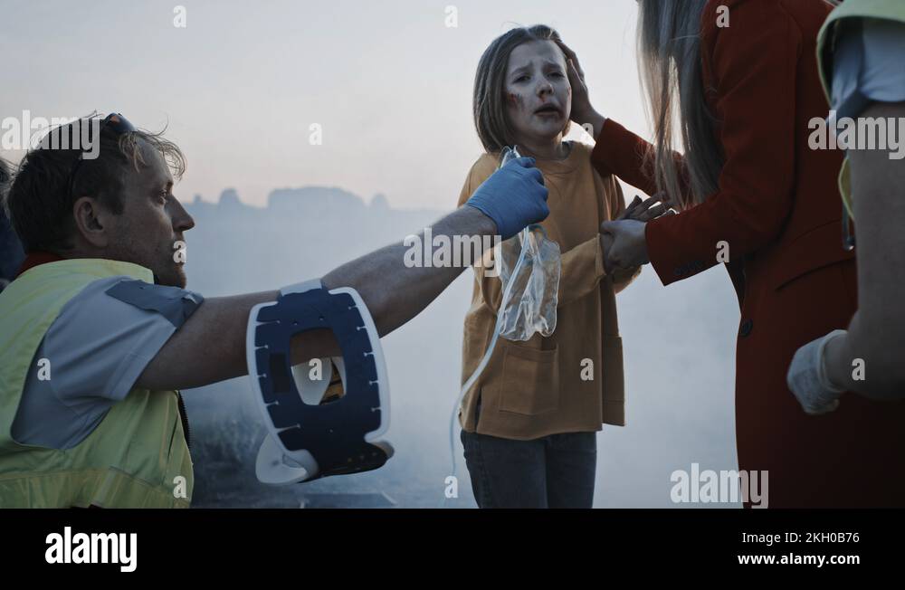 Paramedics Giving First Aid Oxygen Mask to a Young Girl Victim of the ...