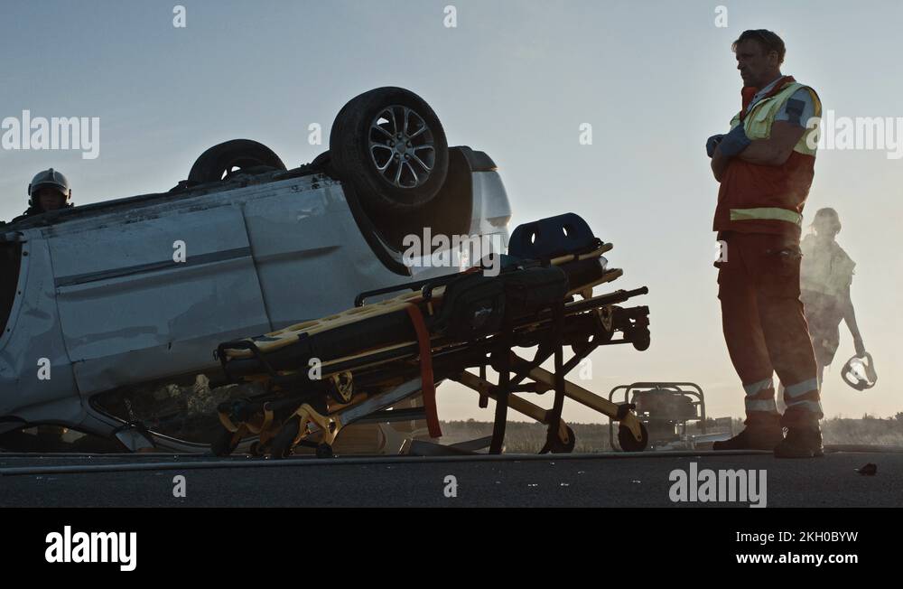 Sad, Sorrowful Paramedic Standing at the Scene of the Terrible Car ...
