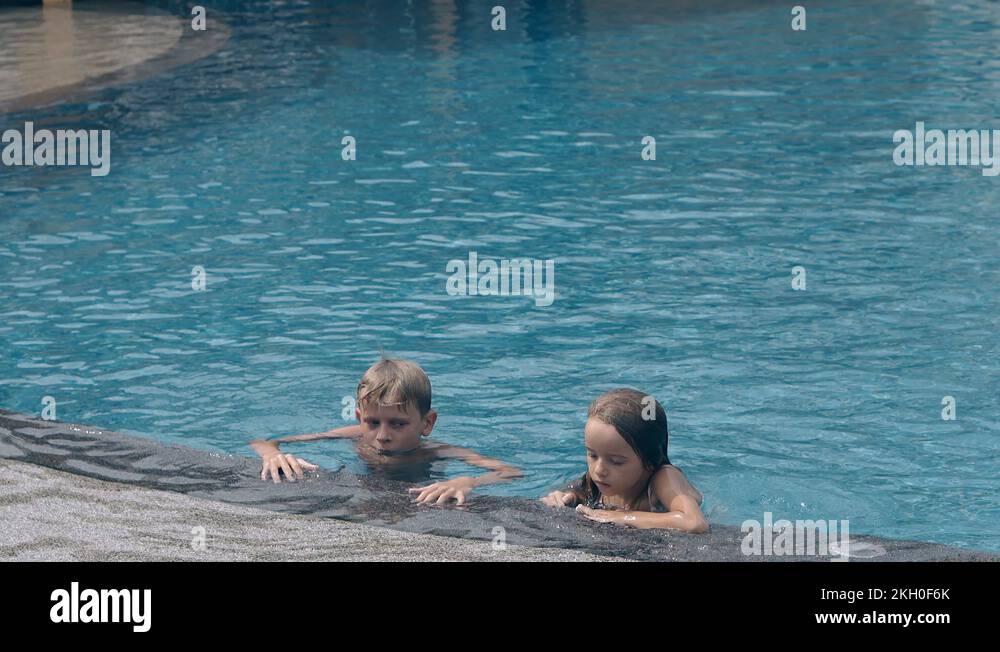 boy in swimming trunks and girl in swimsuit get out of pool Stock Video ...
