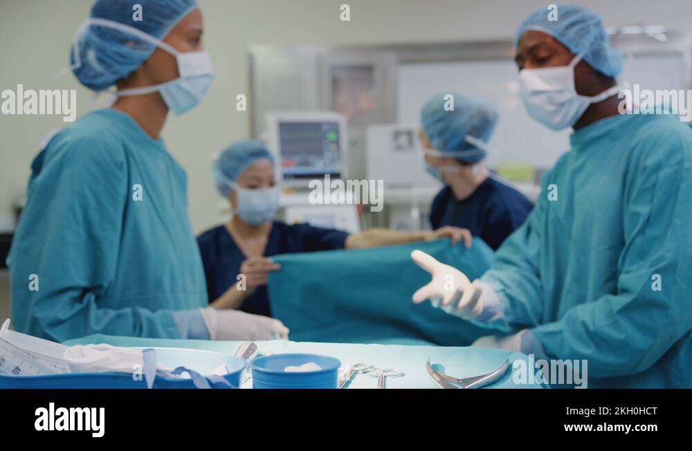 Nurse Hands Surgeon Medical Instruments As Surgical Team Work On ...