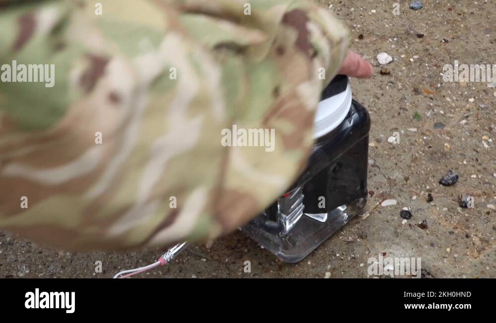 EOD soldier placing screw cap on improvised explosive device Stock ...