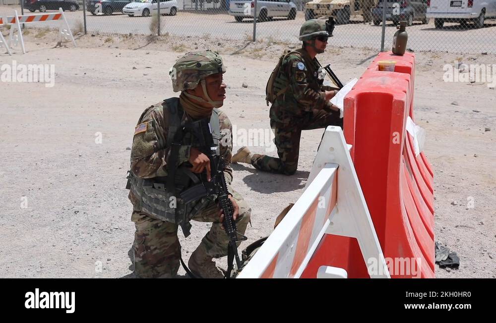 Armed soldiers kneeling behind road block barriers Stock Video Footage ...