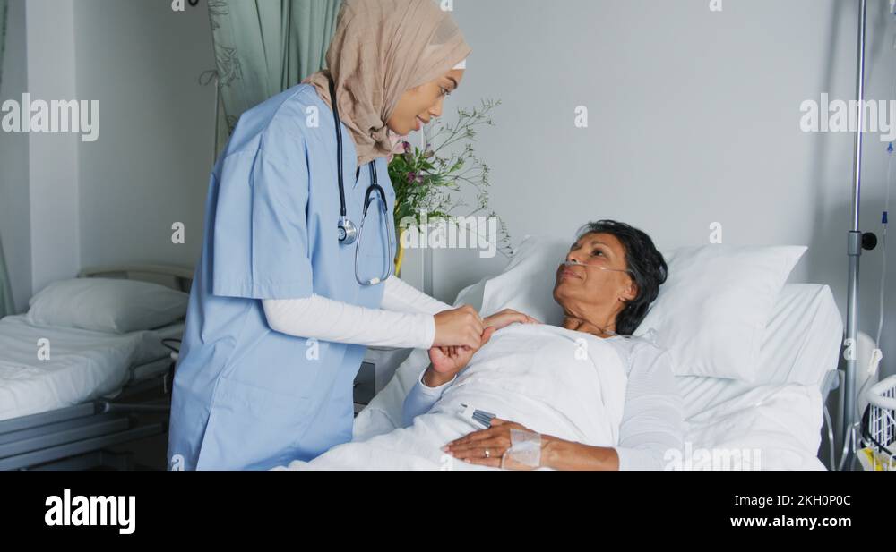 Female doctor comforting patient lying on hospital bed 4k Stock Video ...
