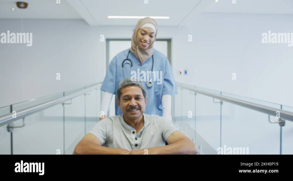 Young doctor pulling wheelchair 4k Stock Video Footage - Alamy