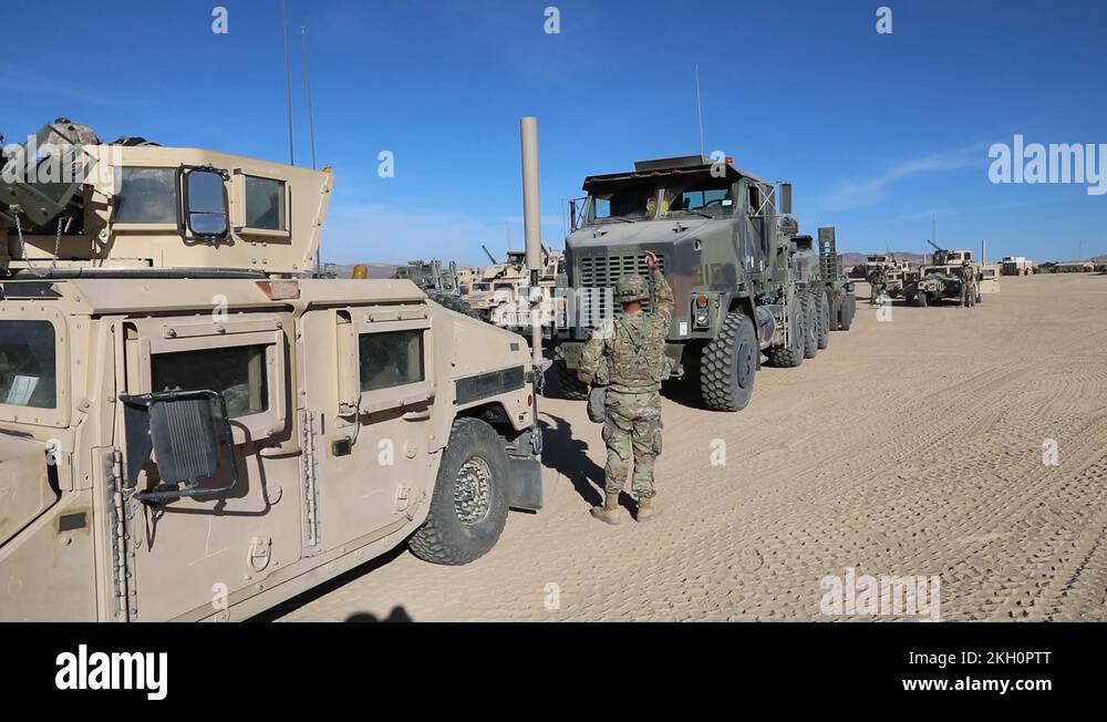 Up-armored Humvee and low-loader parking in desert for Hickory Sting ...