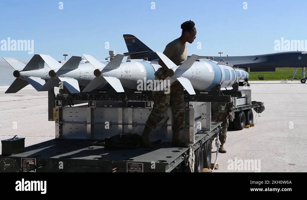 Munitions airman pushing bomb into position for bomb loader Stock Video ...