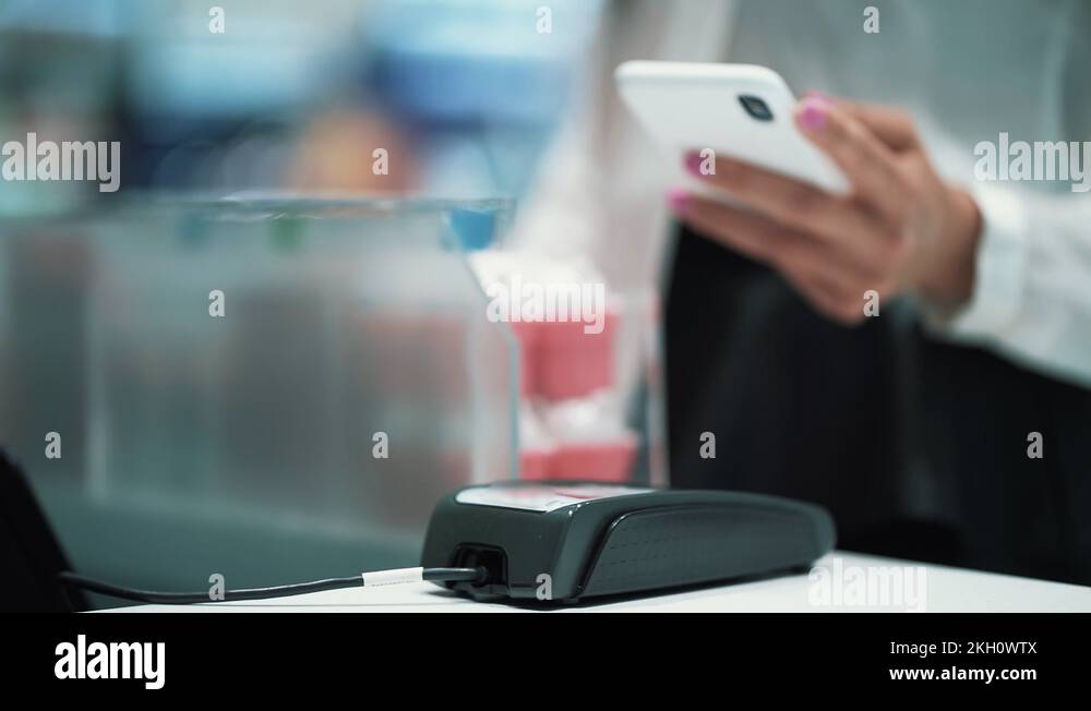 Close up woman hand pays for goods using phone, contactless payment ...