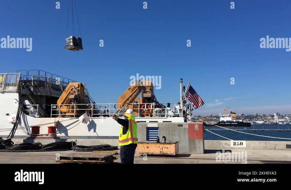 Crane moving pallet of seized cocaine from deck of Coast Guard Cutter ...