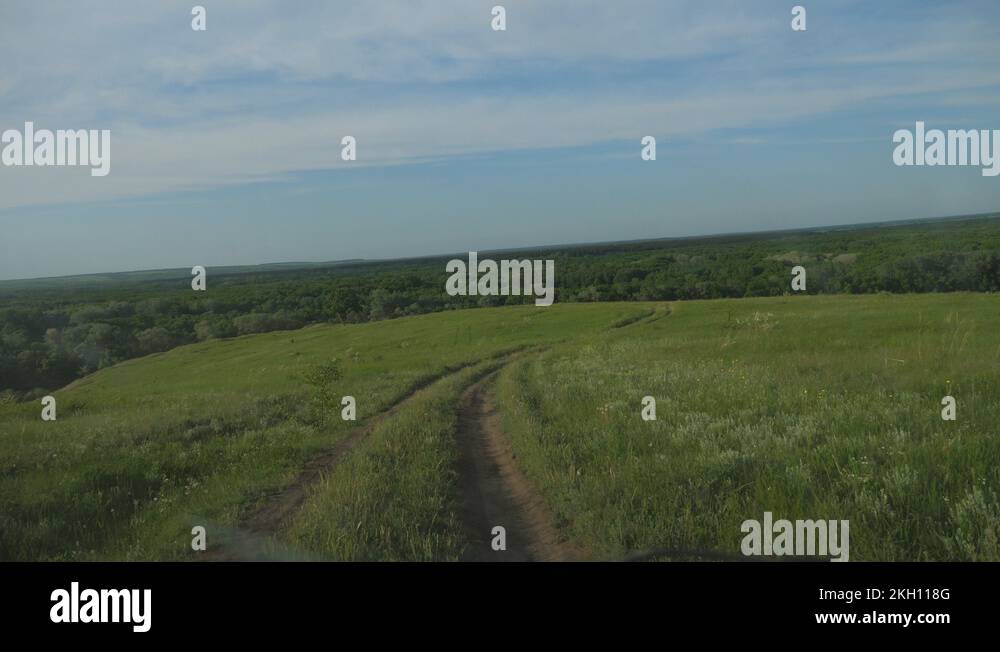 the car is driving along a country road nature .man driving a car on ...