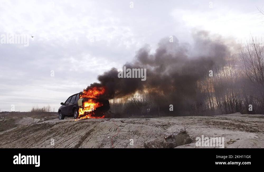 Huge smoking flame of fire completely burns dirty old car left on ...