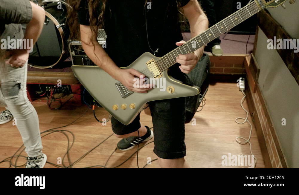 Musical metal band. Group of musicians playing rock music on stage. 4K ...