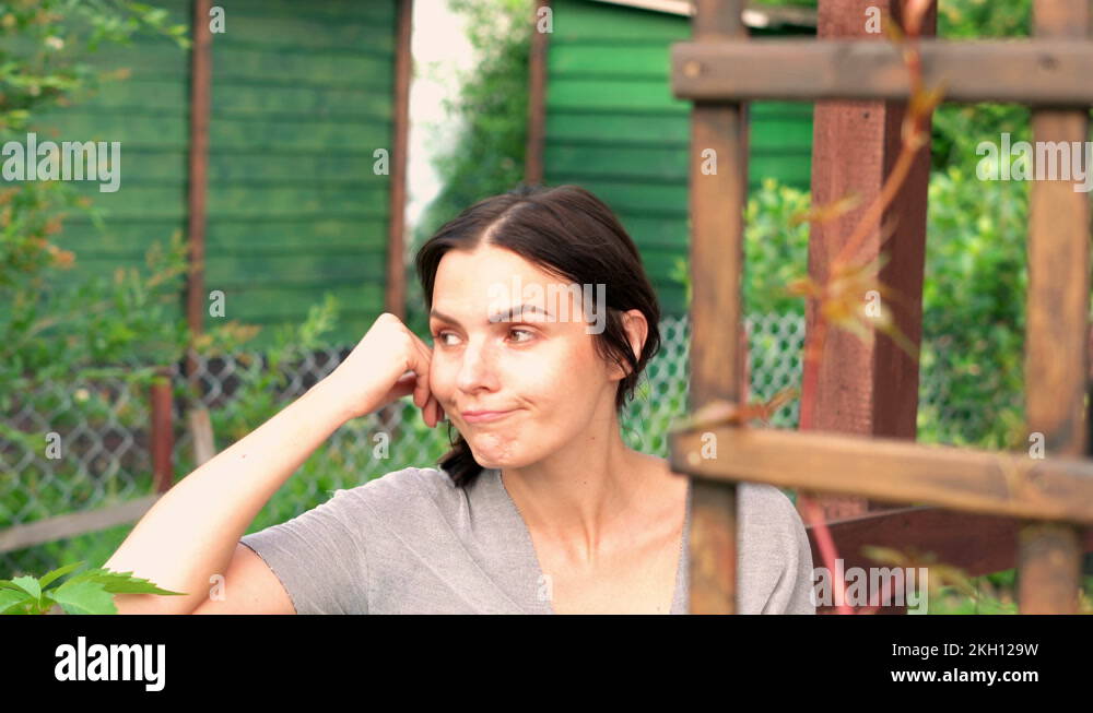 Sad woman sitting on the porch in garden, 4K Stock Video Footage - Alamy