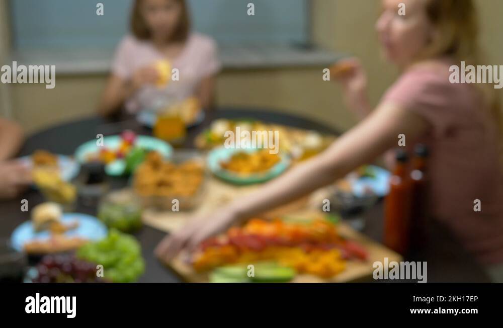 The concept of family leisure and food. people at the big table eating ...