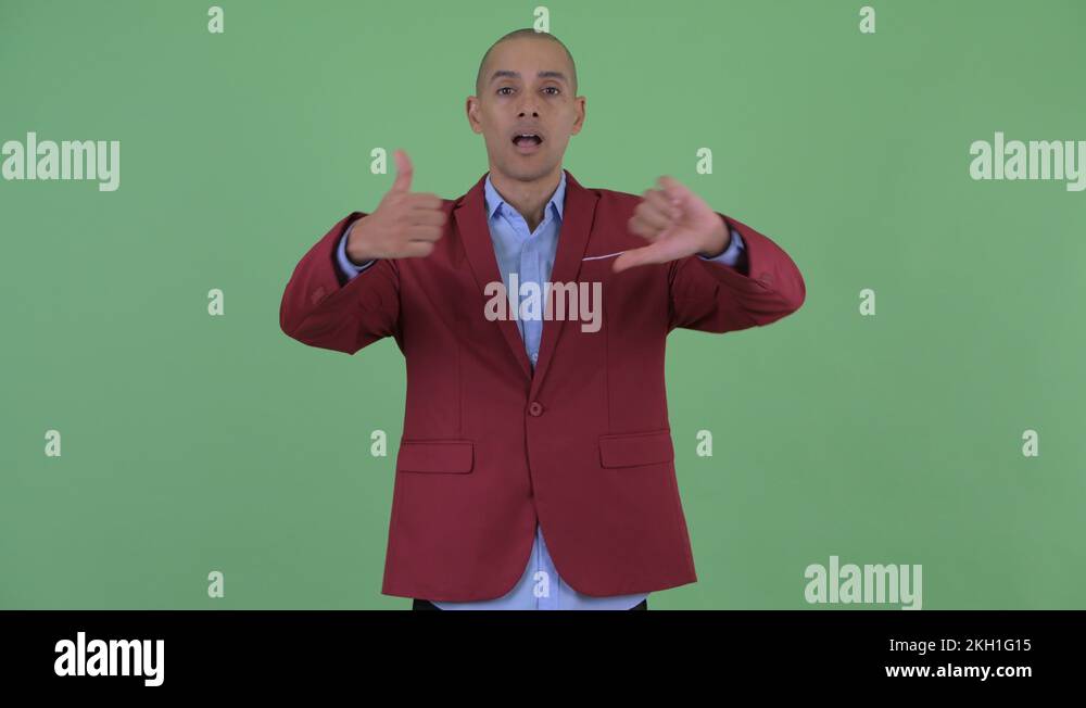 Confused bald multi ethnic businessman choosing between thumbs up and ...
