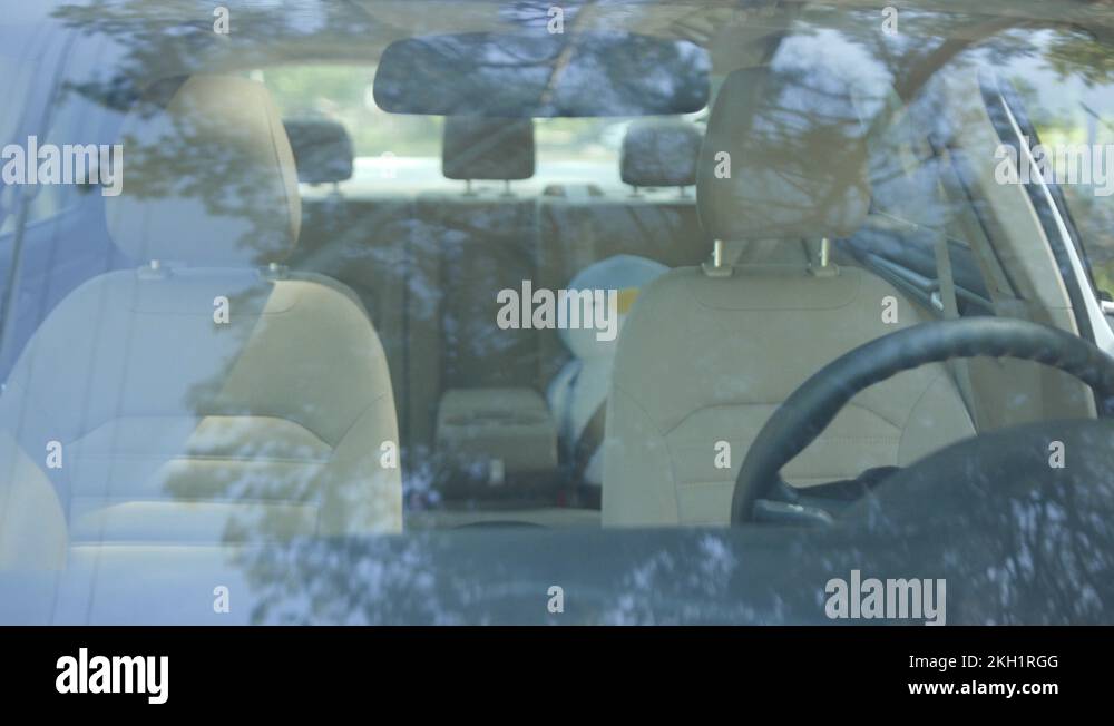 Front view adorable young family sitting inside the modern car. Happy ...