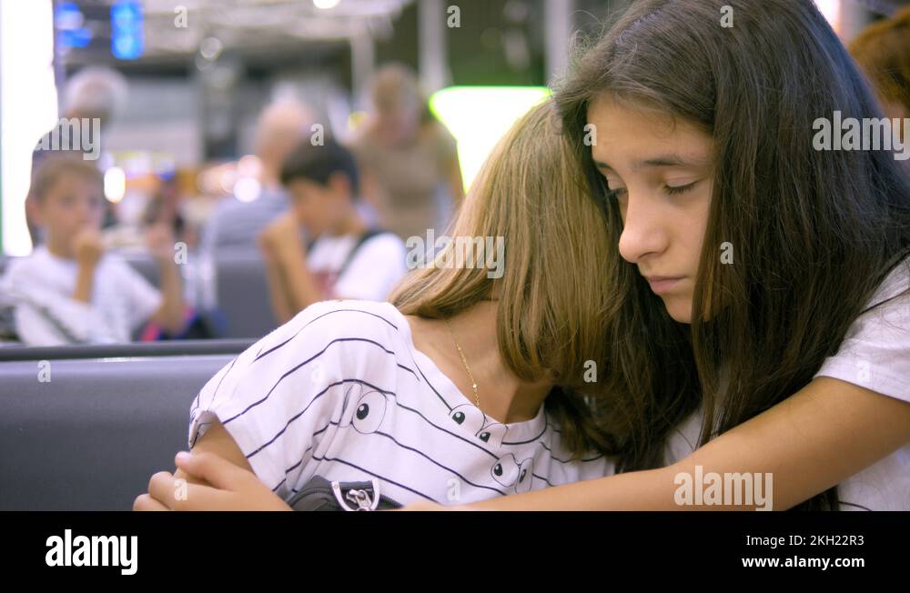 concept of separation. two girls girlfriends say goodbye at the airport ...