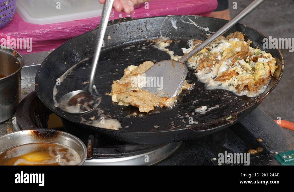 Thai people cooking fried mussel with egg and crispy flour or oyster ...