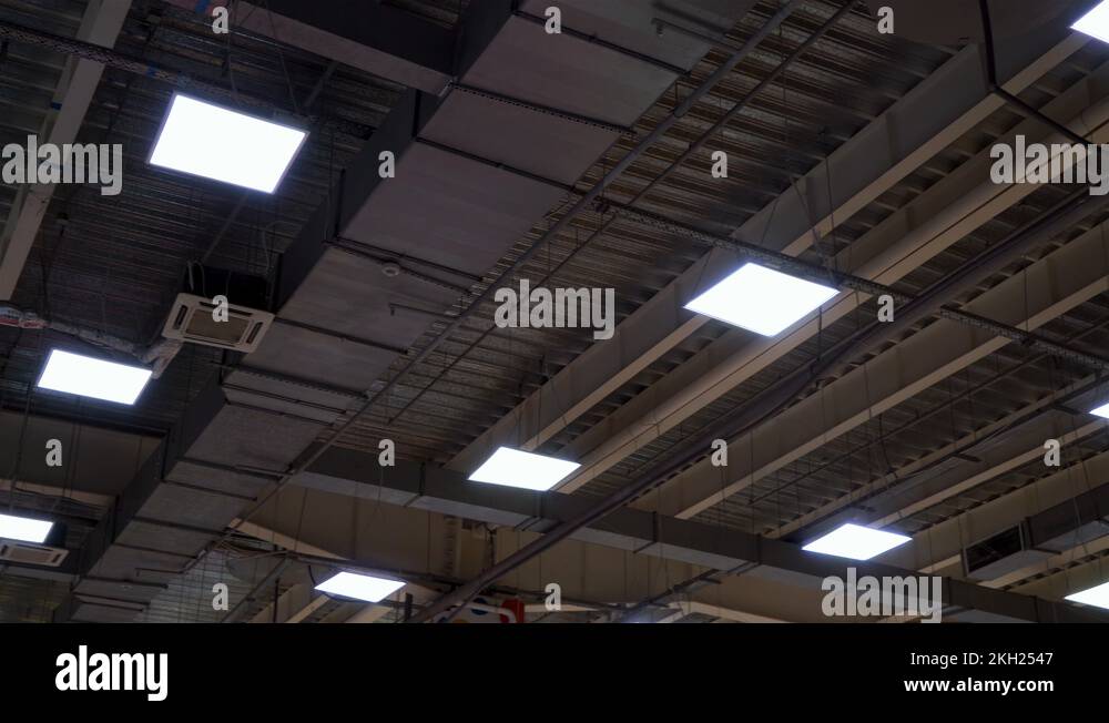 long pipes of hvac system and lamps hang on ceiling of big mall Stock ...
