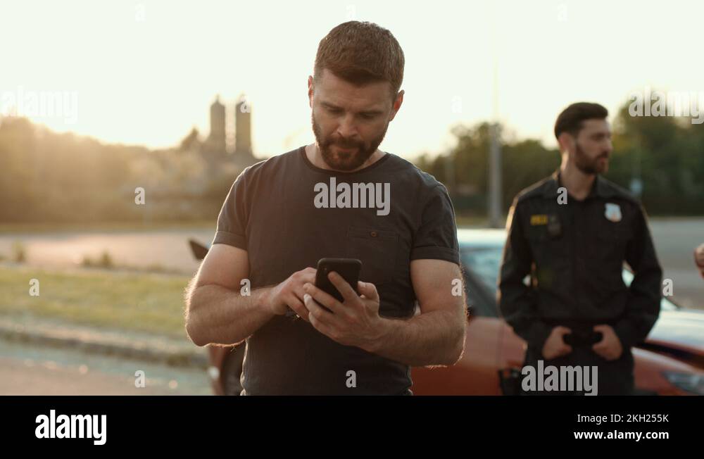 Confused middle-aged man in trouble using a smartphone outdoors. Male ...