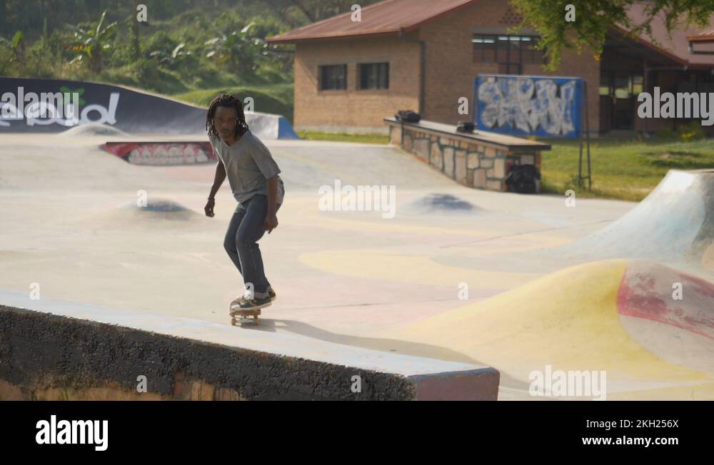 skateboarder jumping on the grind box in the skatepark slow motion ...