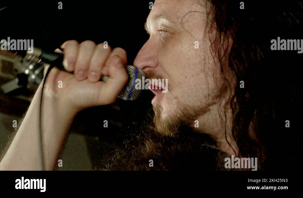 Musical metal band. Group of musicians playing rock music on stage. 4K ...