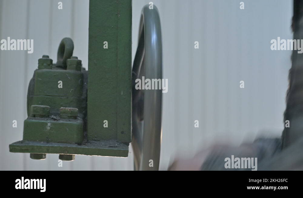 Close-up of hands A male researcher rotates the manual wheel of the ...