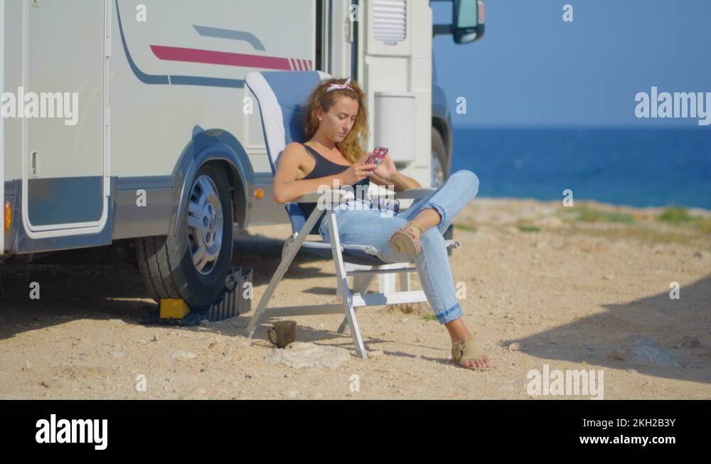 Girl making selfie near her camper. Traveling woman by mobile motor ...
