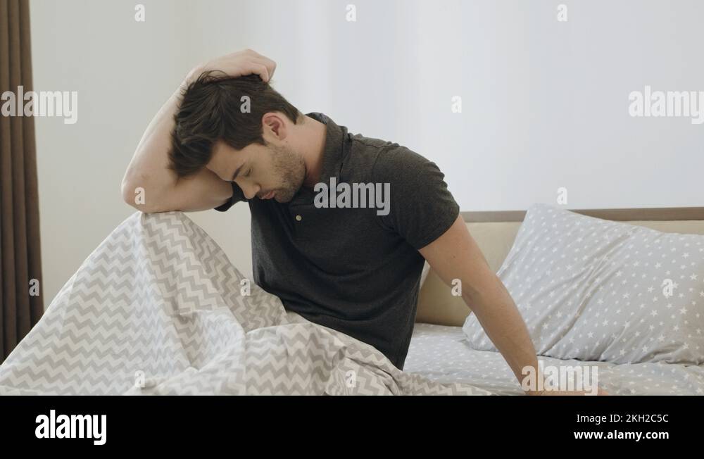 Drunk man trying to remember party night. Sleepy man waking up in ...