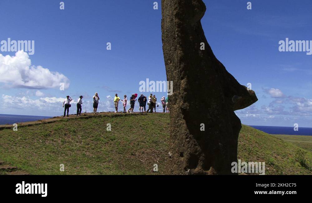 People behind a Moai statue in Easter Island Stock Video Footage - Alamy