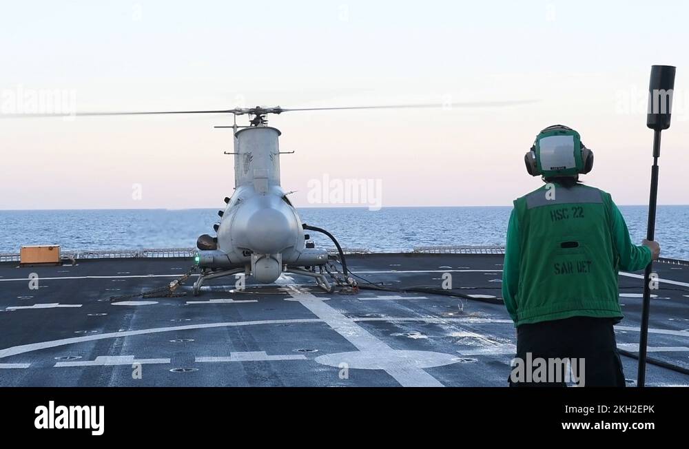 Seaman watching MQ-8B Fire Scout UAV during refueling aboard USS ...