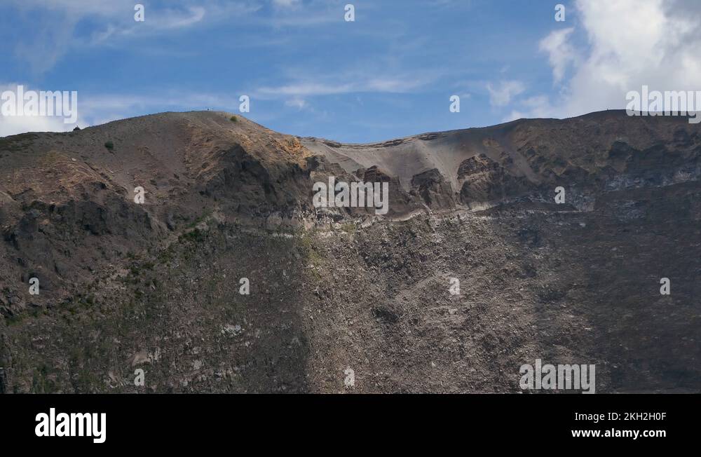 Tilt down over the Mount Vesuvius with a blue sky and clouds in ...