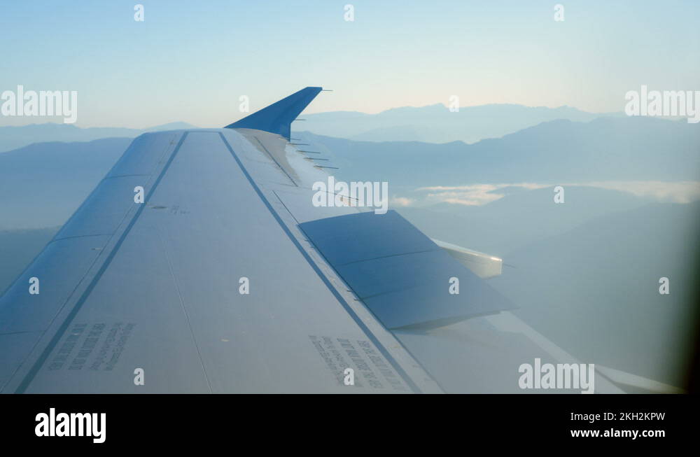 Aeroplane. View of airplane wing of aircraft flying above the clouds ...