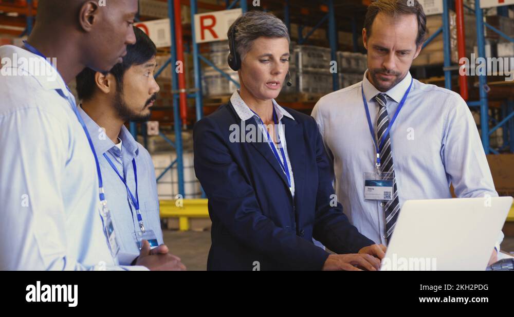 Managers and staff having a meeting in a warehouse loading bay 4k Stock ...
